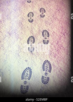 Human boots footprints in snow. Boot print on the snow Stock Photo - Alamy