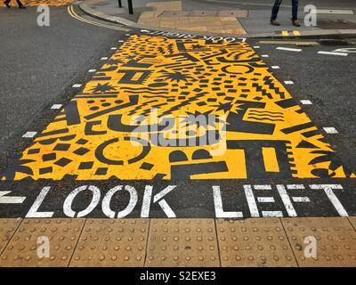 look left and double yellow road markings at the edge of a pavement on ...