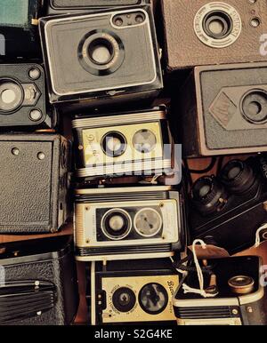 A collection of old antique vintage film cameras of different kinds on ...