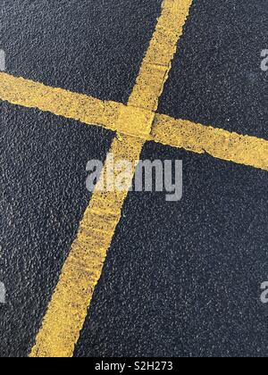 Painted yellow cross, road markings Stock Photo - Alamy