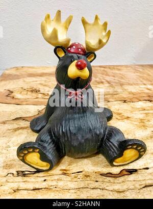 Reindeer horns with a red nose on yellow background. New Year's mood ...