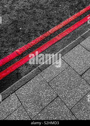 Double red line road markings on a UK road Stock Photo - Alamy