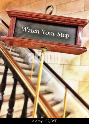 Watch your step sign on old train steps Stock Photo - Alamy