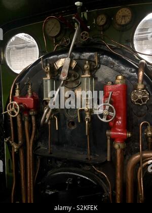 Engine train driver inside of locomotive control room Stock Photo - Alamy