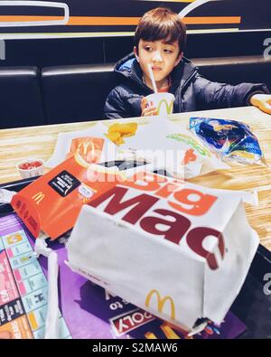 Child eating McDonald's Big Mac hamburger England UK Stock Photo - Alamy