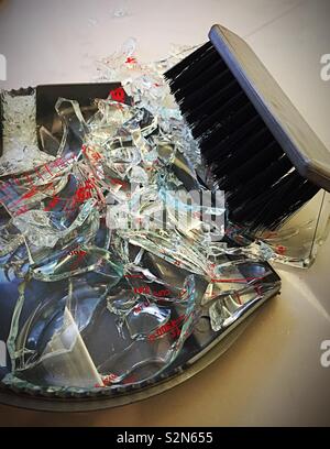 Broken glass and a dustpan and brush Stock Photo - Alamy