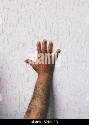 Man’s hand against the wall Stock Photo - Alamy