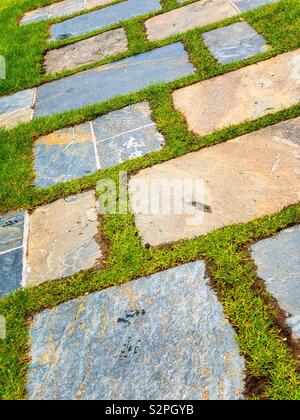 Natural stone paving laid in segment arches Stock Photo - Alamy