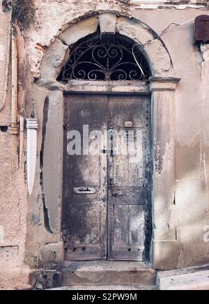 old rotten wooden doors with peeling color in the historic district of ...