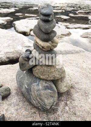 rocks stacked at edge of river Stock Photo - Alamy