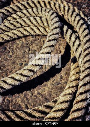Coil of rope lying on the ground Stock Photo - Alamy