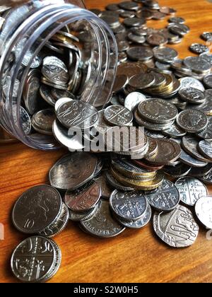 Money spilling from a Piggy Bank Stock Photo - Alamy