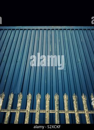 A fence in front of a factory building with a dramatic sky Stock Photo ...