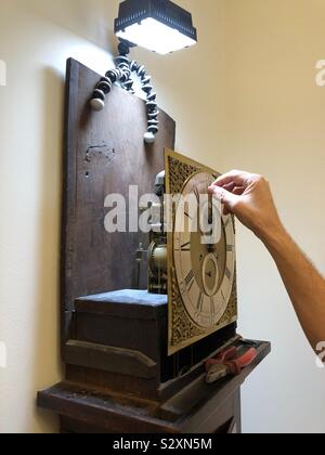 a man fixing clock hand Stock Photo - Alamy