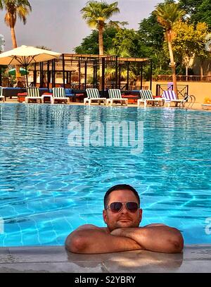 Man chilling in the swimming pool Stock Photo - Alamy