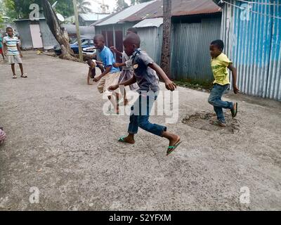 Comoran children playing football in the streets of Moroni, Comoros ...