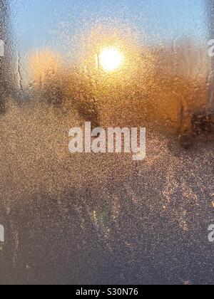 Sunrise through frosty window Stock Photo - Alamy