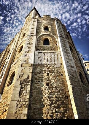 A low angle shot of a castle corner tower under the blue sky on a sunny ...