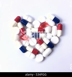 Heart made of white heart shape tablets isolated on white background ...