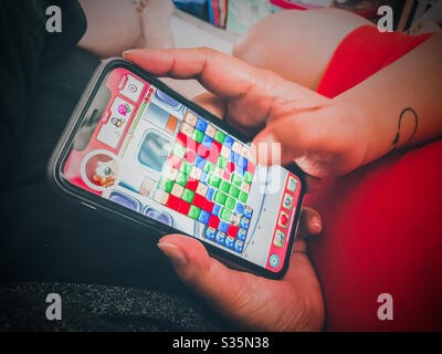 Playing mobile game on cellphone Stock Photo - Alamy
