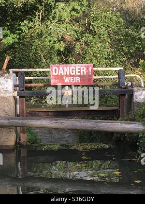 Warning sign near weir Stock Photo - Alamy