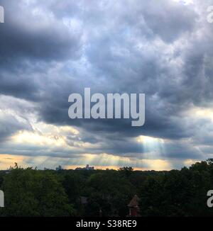 Rays of sun streaming through the clouds Stock Photo - Alamy