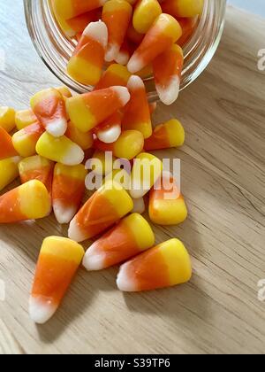 Colorful candy spilling out of a jar onto white background Stock Photo ...
