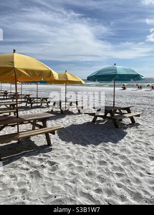 Colorful beach umbrellas and picnic tables on Florida white sand beach ...