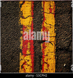 Double red line road markings on a UK road Stock Photo - Alamy