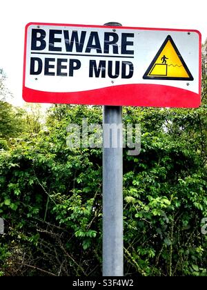 Beware deep mud sign near pond in Brockwell Park Stock Photo - Alamy