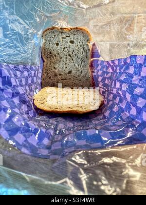 Sliced bread in a plastic bag on white surface Stock Photo - Alamy