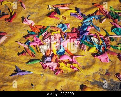 Burst balloons on the ground Stock Photo - Alamy