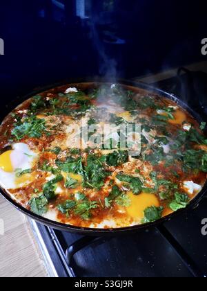Shakshouka a traditional north African dish of fried eggs mixed with ...