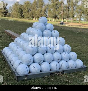 Pyramid of golf balls at a Golf driving practice range Stock Photo - Alamy