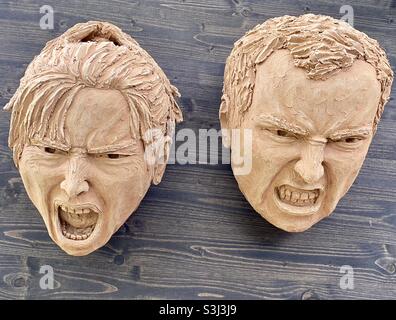 Clay Sculpture of Two Faces Interacting With Wooden Background Stock ...