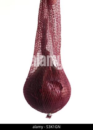 Red onion in a shopping plastic mesh. Close-up, copy space Stock Photo ...