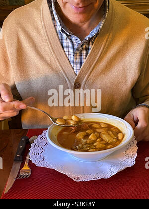 Man eating beans stew Stock Photo - Alamy