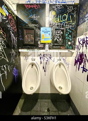 Graffiti on a public urinal toilet pissoir by a canal in Amsterdam ...