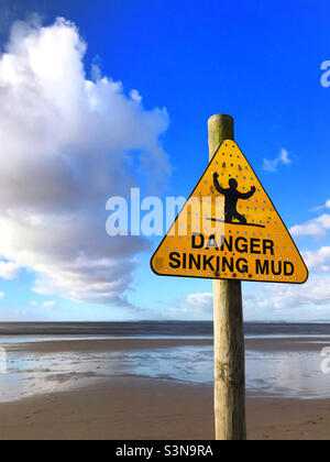 Sinking mud warning sign on beach Stock Photo - Alamy