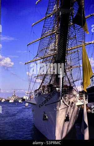 A tall ship in Boston Harbor with Boston Logan Airport behind Stock ...