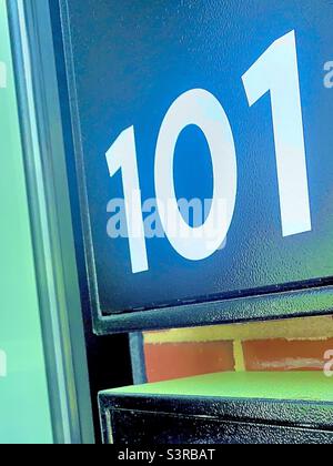 Number 101, one hundred and one, blue numerals on tiles on a pale ...