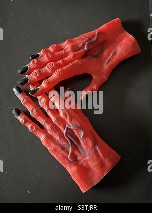 Creepy red devil hands with black nails, Halloween theme Stock Photo ...