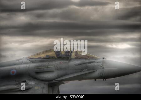 A close-up image of a fighter jet with a painted shark mouth design on ...