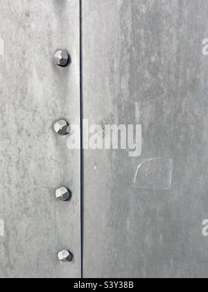 gray metal plates fastened together with rows of rivets Stock Photo - Alamy