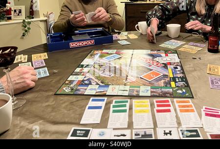 Family playing monopoly Stock Photo - Alamy
