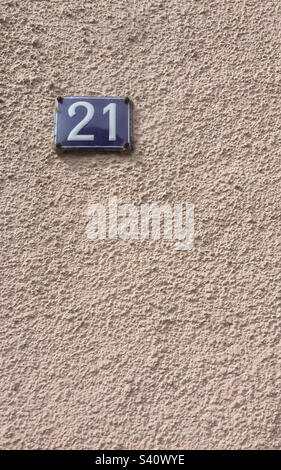 metal house number twenty one on a white plastered wall Stock Photo - Alamy