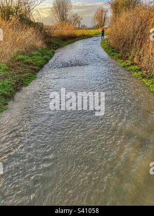 Flooded lane in East Chinnock, Somerset, England, water running down ...