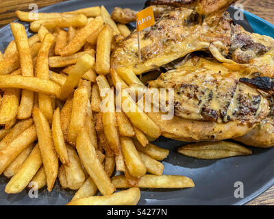 Nando’s whole peri peri chicken and seasoned chips Stock Photo - Alamy