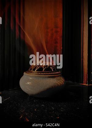 Incense wafting out of its burner in the shape of a person stretching ...