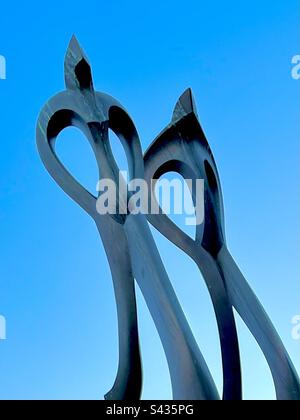 Larger Than Life 2. Black marble statue of two human figures side by ...